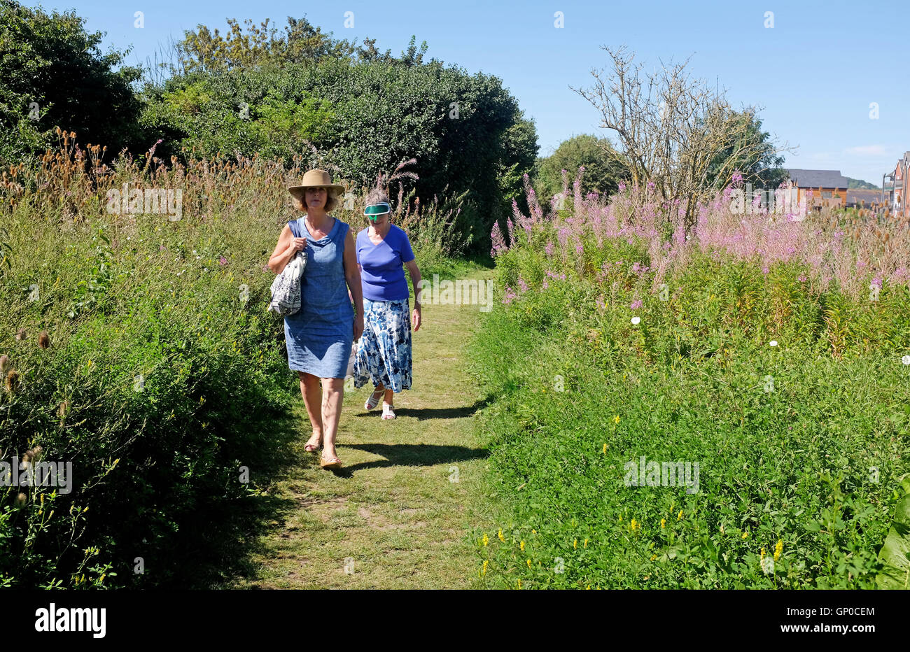Women walking along Lewes Railway Land Wildlife Trust Nature Reserve by ...