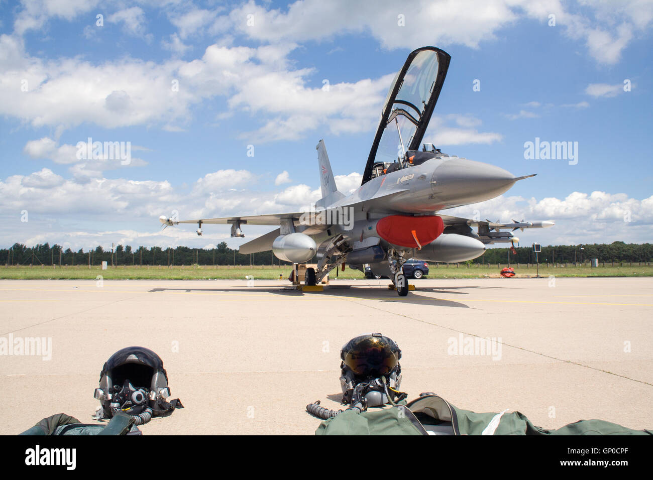 Norwegian Air Force F-16 fighter jet with pilot suits and helmets in ...