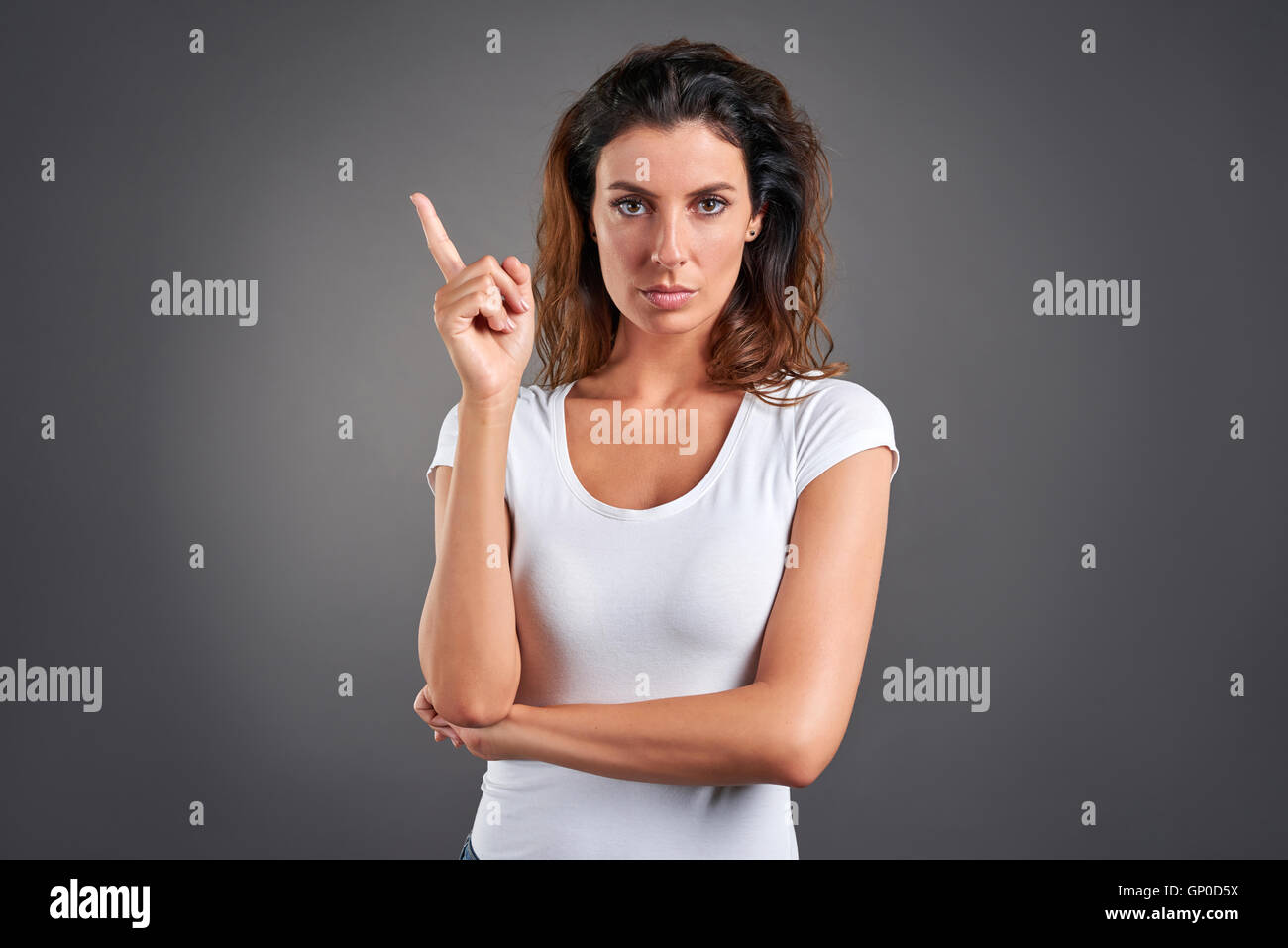 A beautiful young woman feeling and looking suspiciously Stock Photo ...