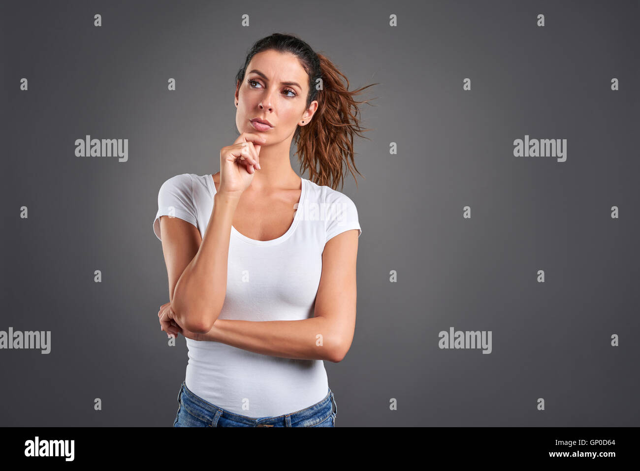 A beautiful young woman thinking Stock Photo - Alamy