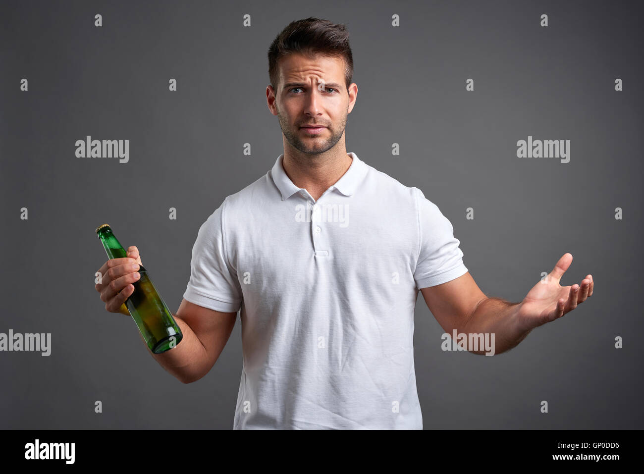 A handsome young man feeling disbelief and looking questioningly while ...