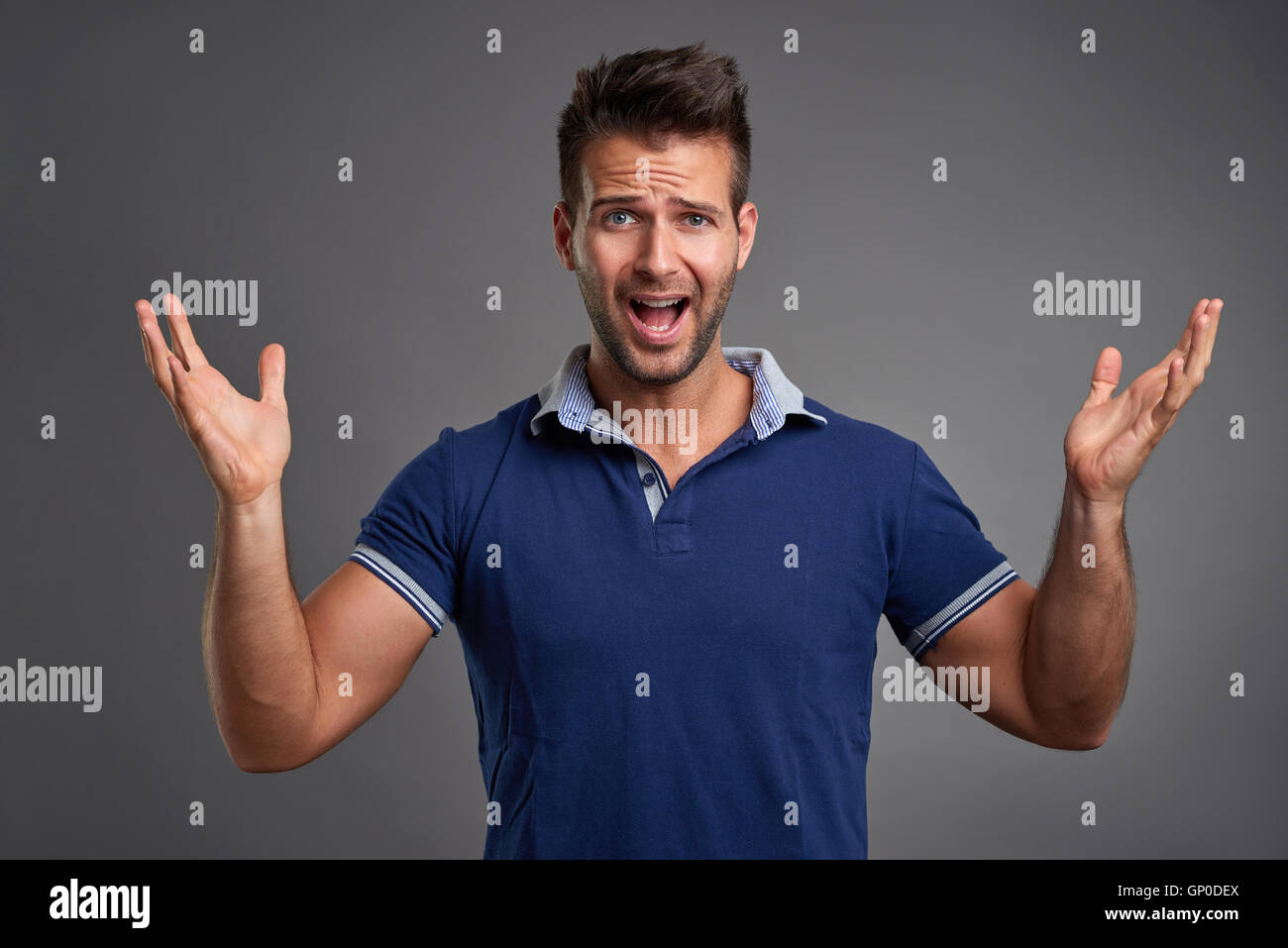 A handsome young man feeling shocked and screaming Stock Photo - Alamy