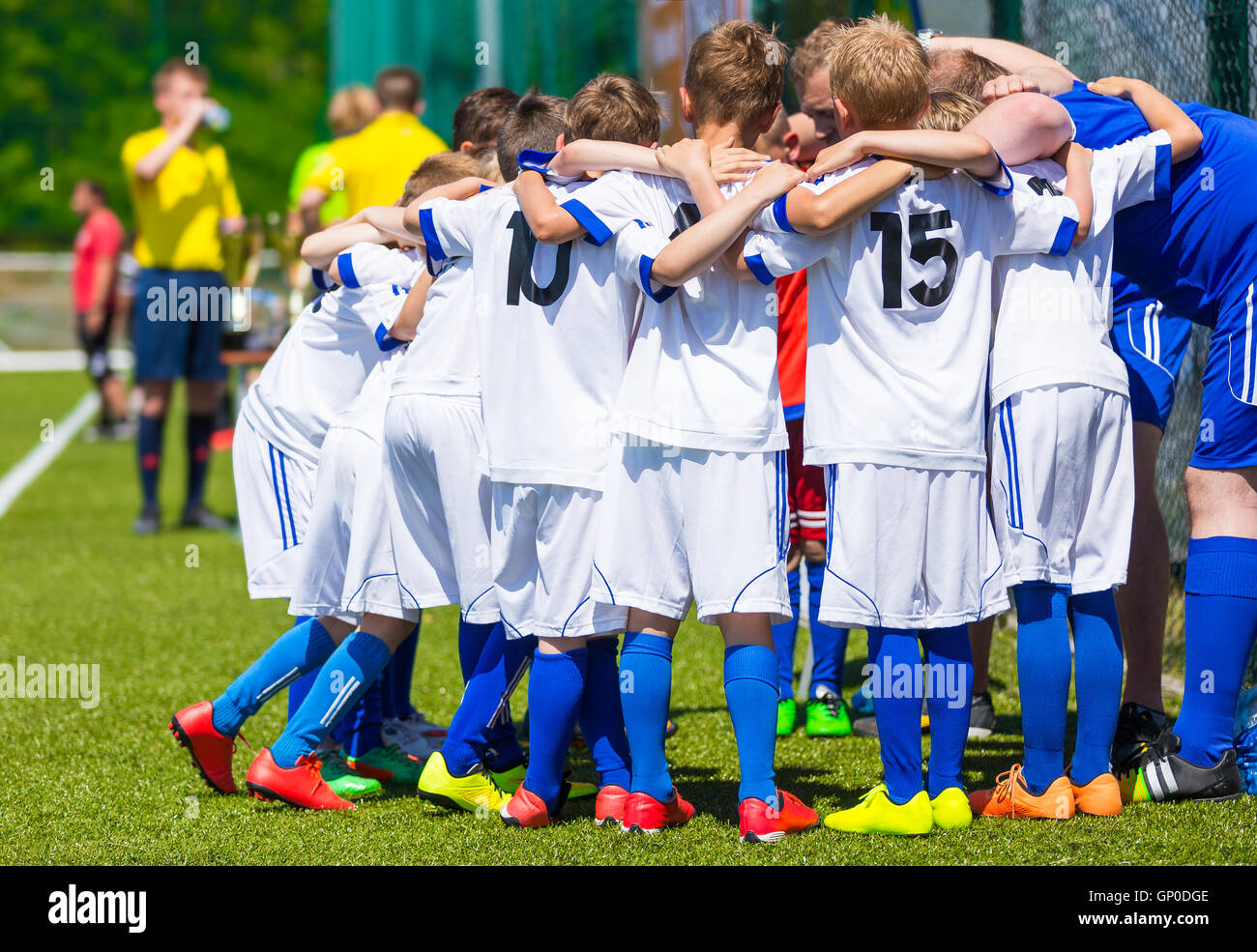 Coach giving young soccer team instructions. Youth soccer team together ...