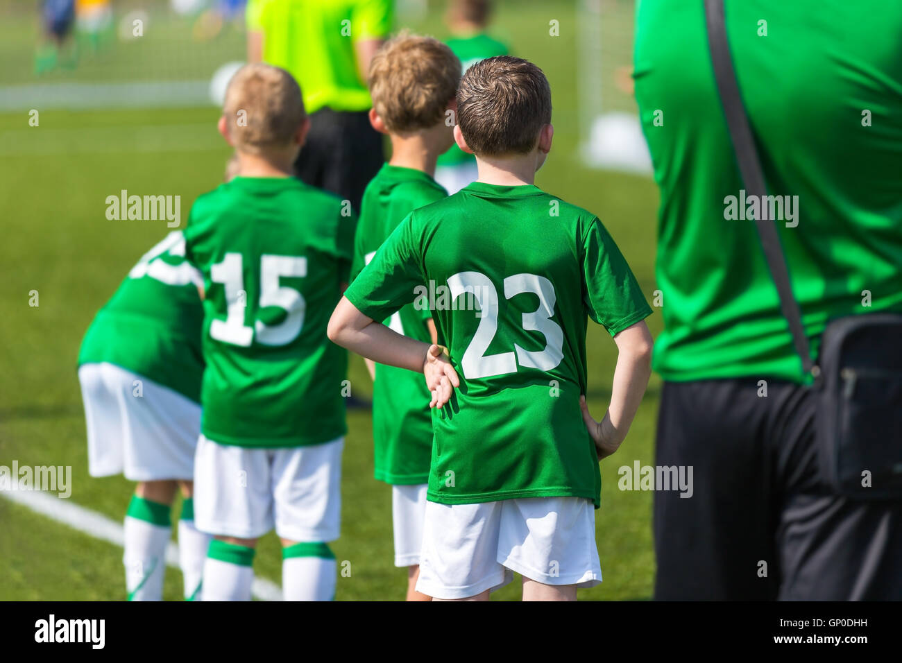 Young boys and soccer coach watching football match. Youth reserve ...