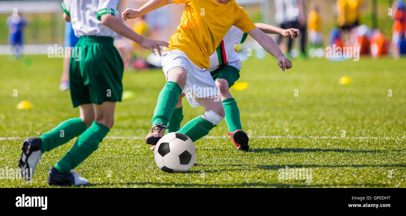 young boys of football academy playing football soccer game. Running ...