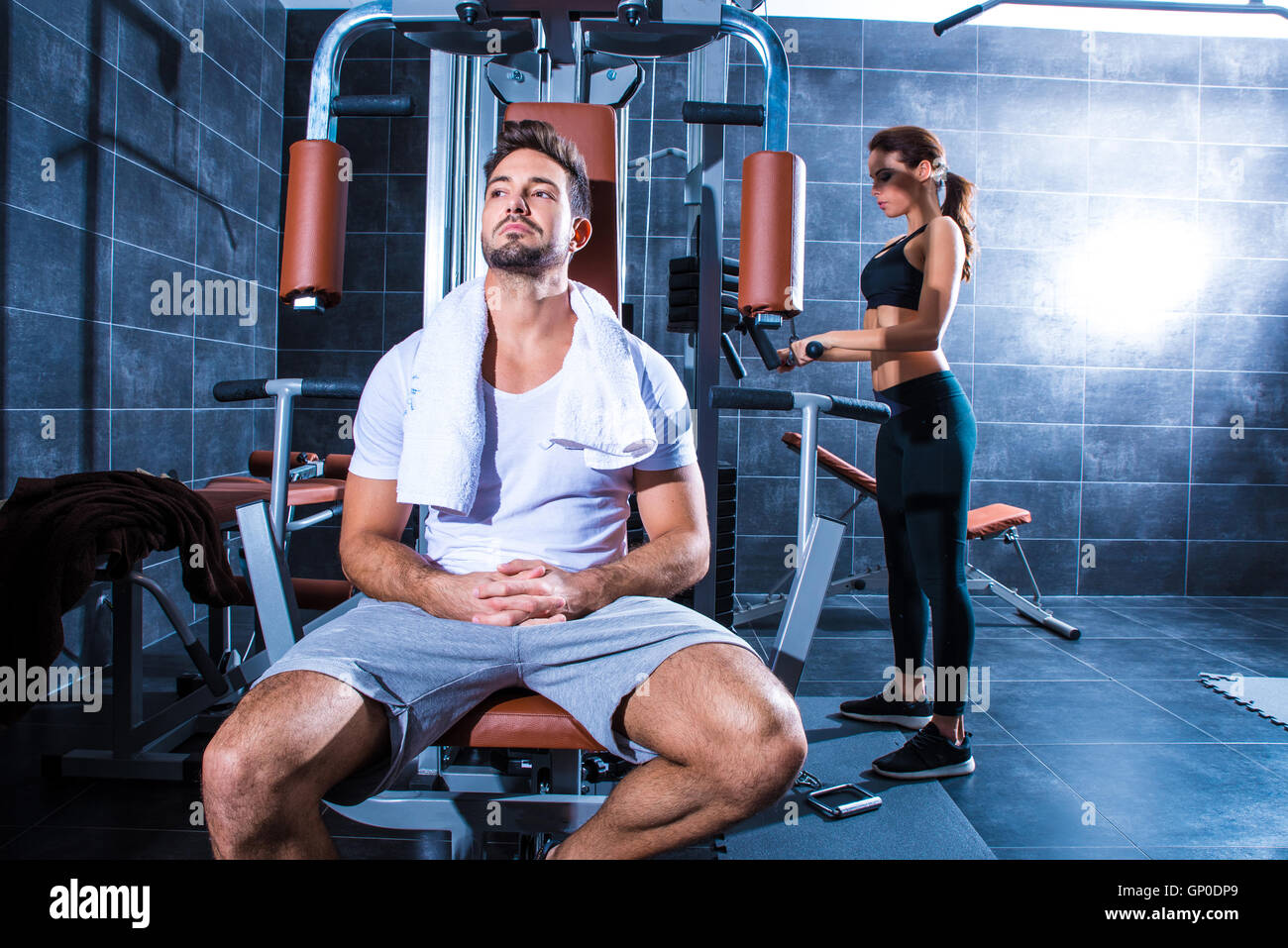 A young couple training together in the Gym Stock Photo - Alamy
