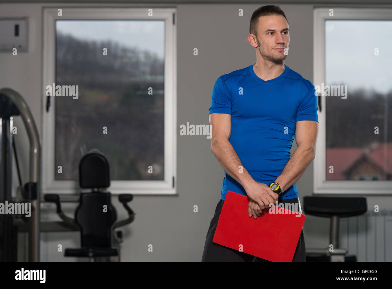 Handsome Personal Trainer With A Clipboard In Fitness Center Gym Stock ...