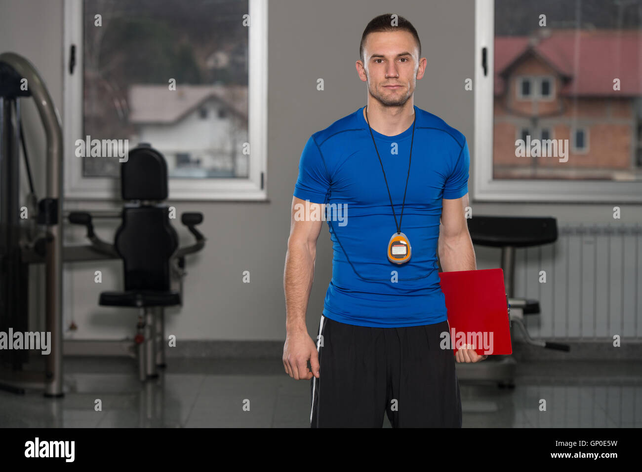 Handsome Personal Trainer With A Clipboard In Fitness Center Gym Stock ...