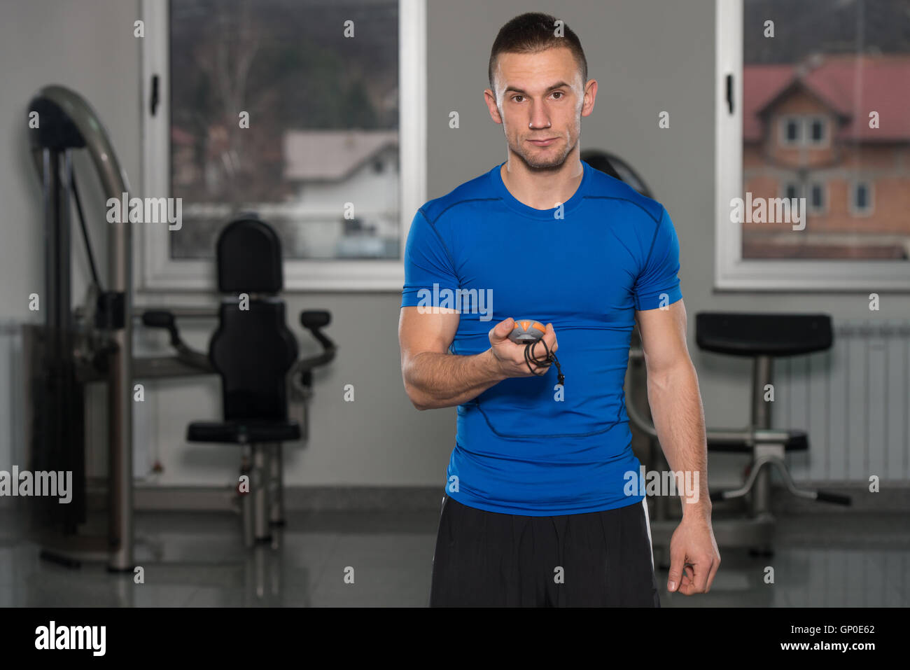 Handsome Personal Trainer With Stopwatch In A Fitness Center Gym ...