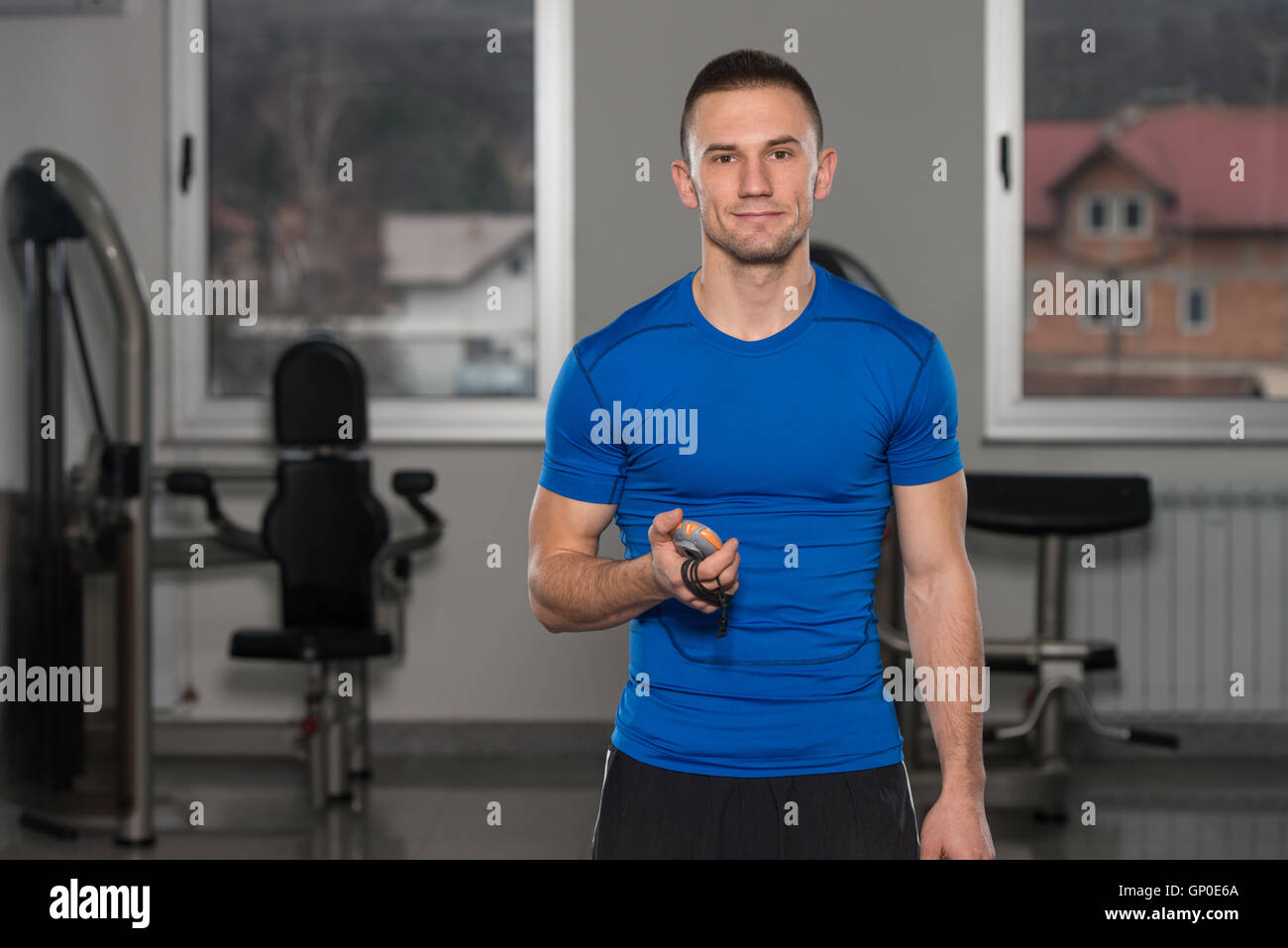 Handsome Personal Trainer With Stopwatch In A Fitness Center Gym ...