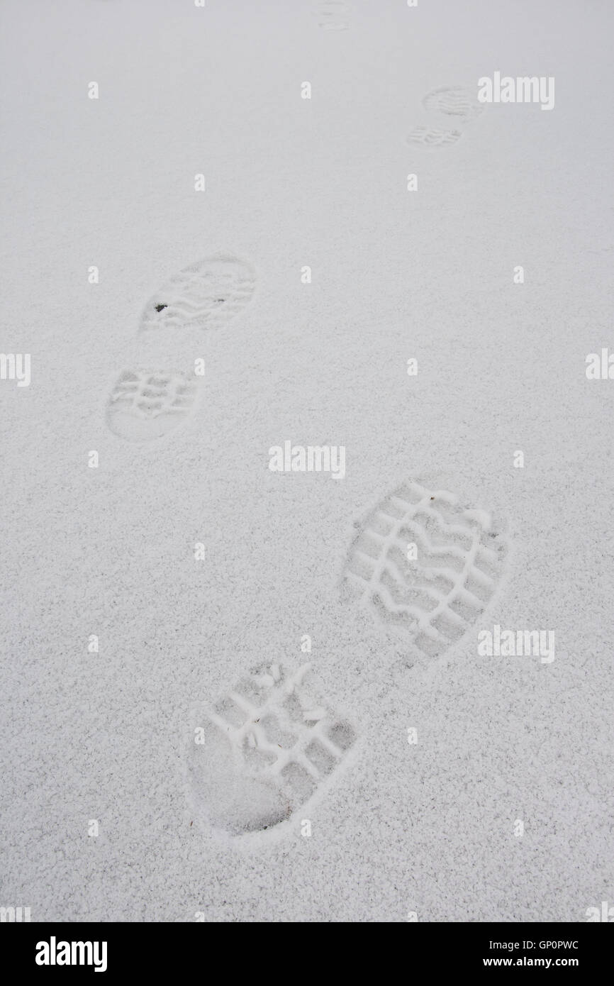 Human boot footprints (steps) in the snow Stock Photo - Alamy