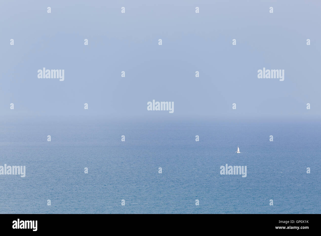 Boat in the distance at sea Stock Photo - Alamy