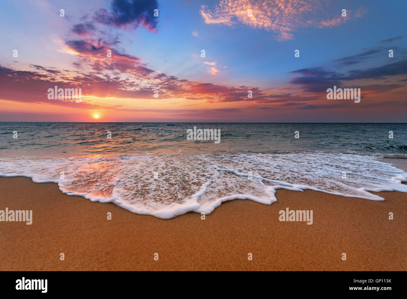 Colorful ocean beach sunrise Stock Photo - Alamy