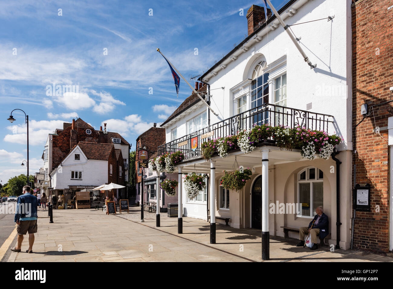 An old man sits on a bench outside Tenterden Town Hall and watches the ...