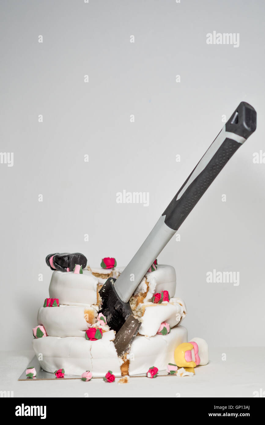 Wedding cake chopped with axe Stock Photo - Alamy