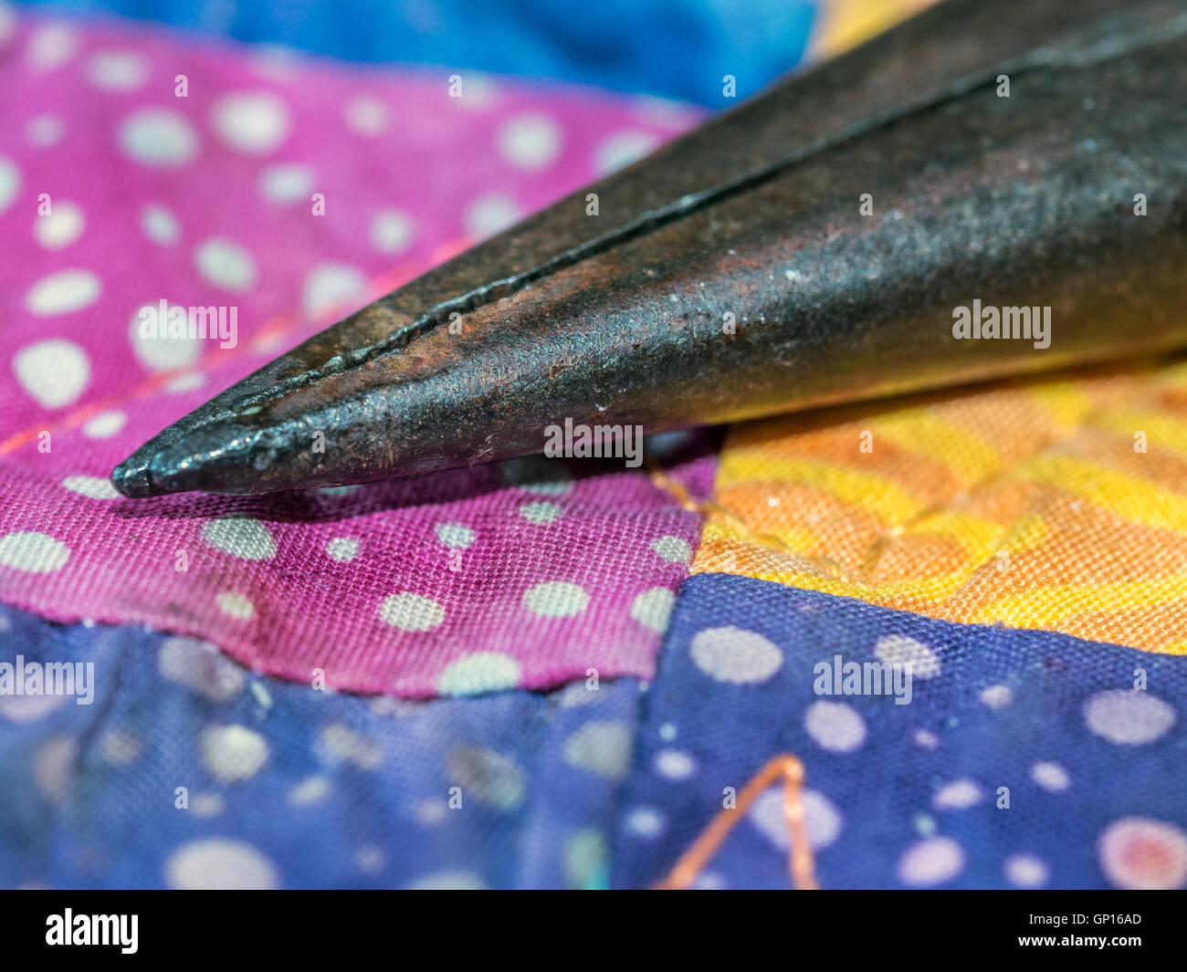 Tip of needle nose pliers on quilt Stock Photo - Alamy