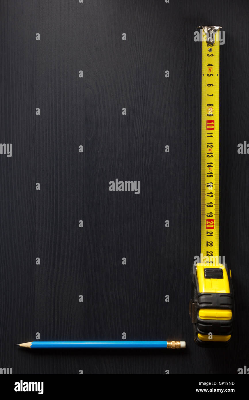 tape measure and pencil on wooden texture Stock Photo - Alamy