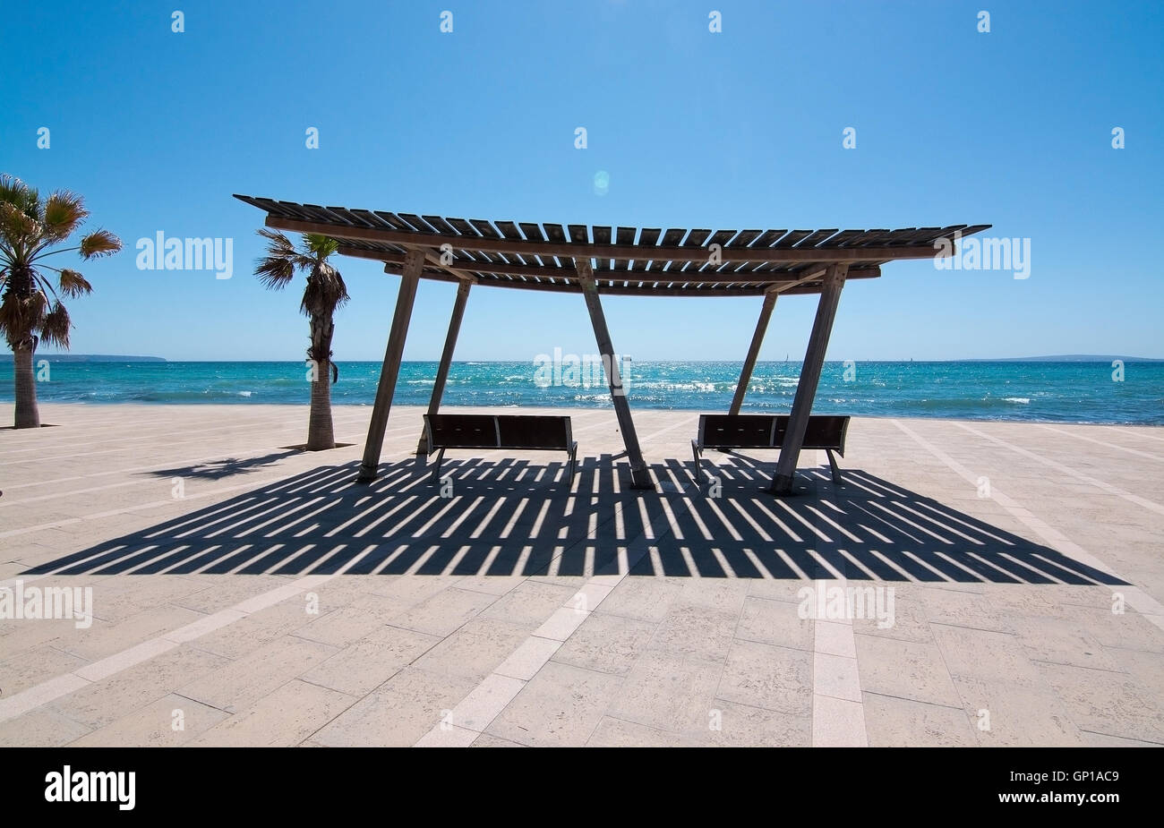 Seating benches with ocean view and wooden shade structure. Mallorca ...