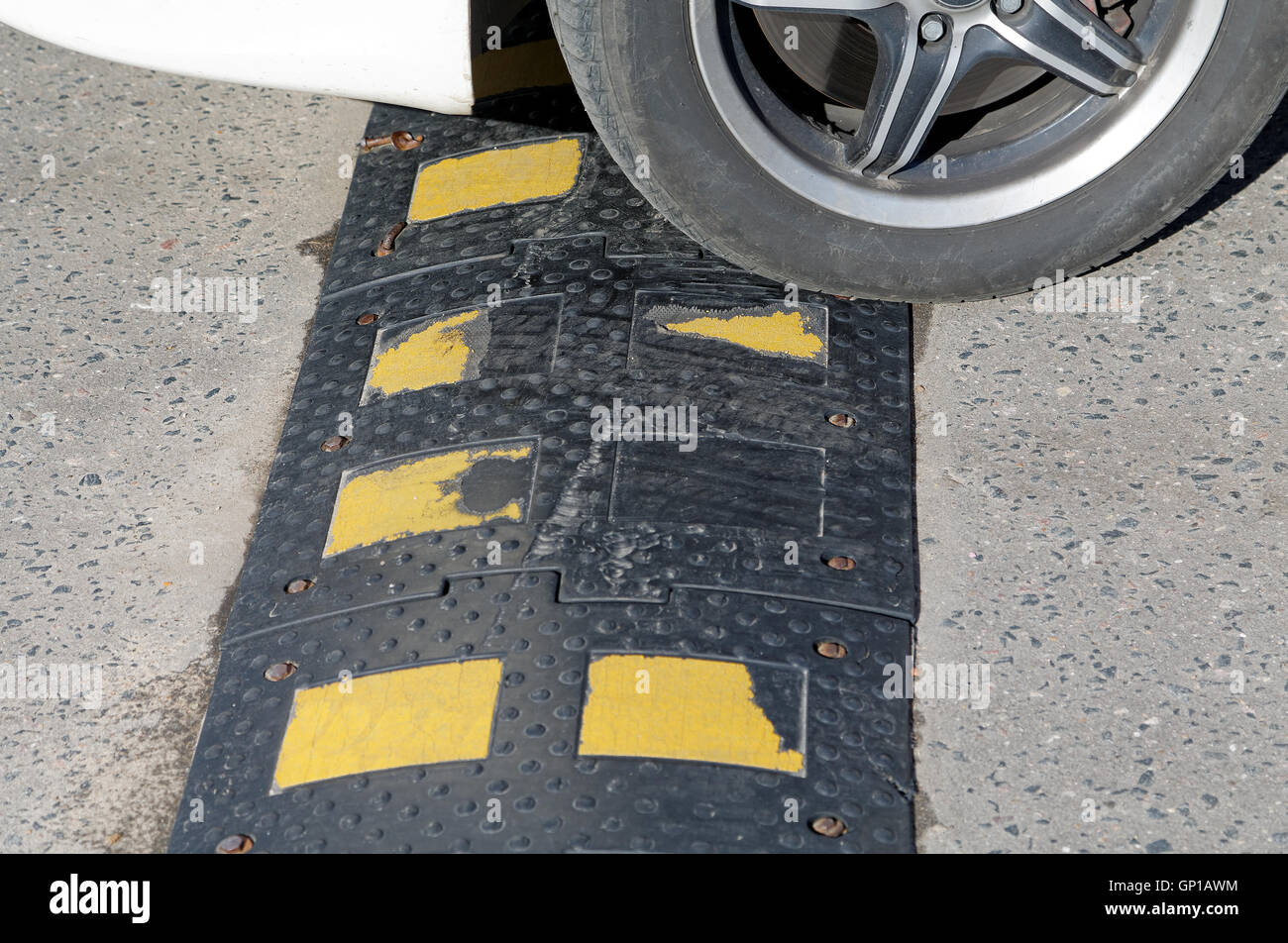 car tire encounters a sleeping policeman Stock Photo - Alamy