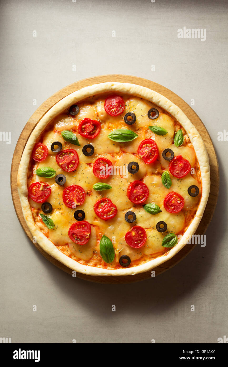 italian pizza at table surface background Stock Photo - Alamy