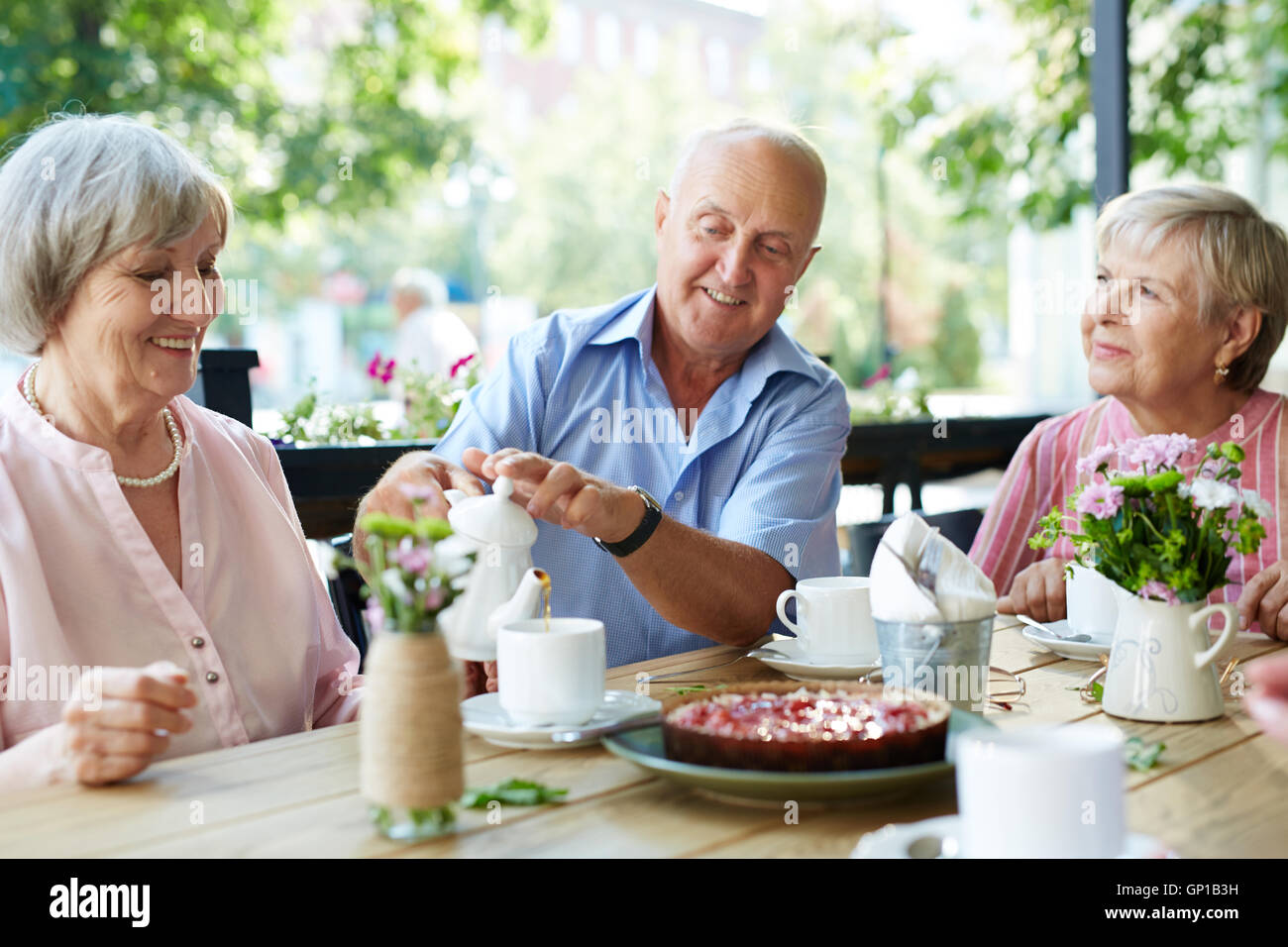 Group of senior friends having tea with cake in cafe Stock Photo - Alamy