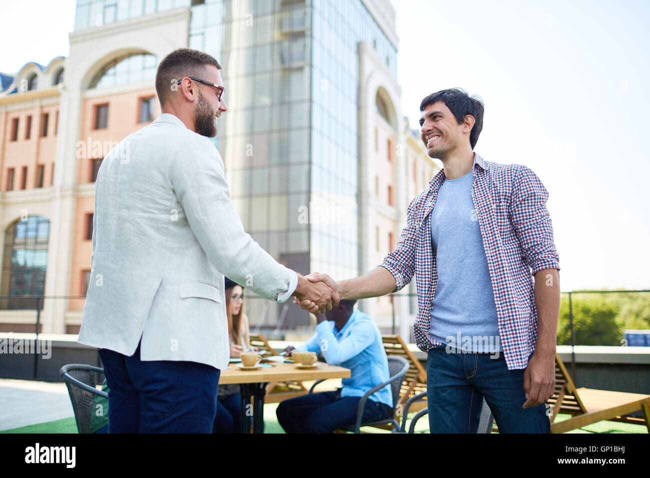 Successful business partners handshaking outdoors Stock Photo - Alamy