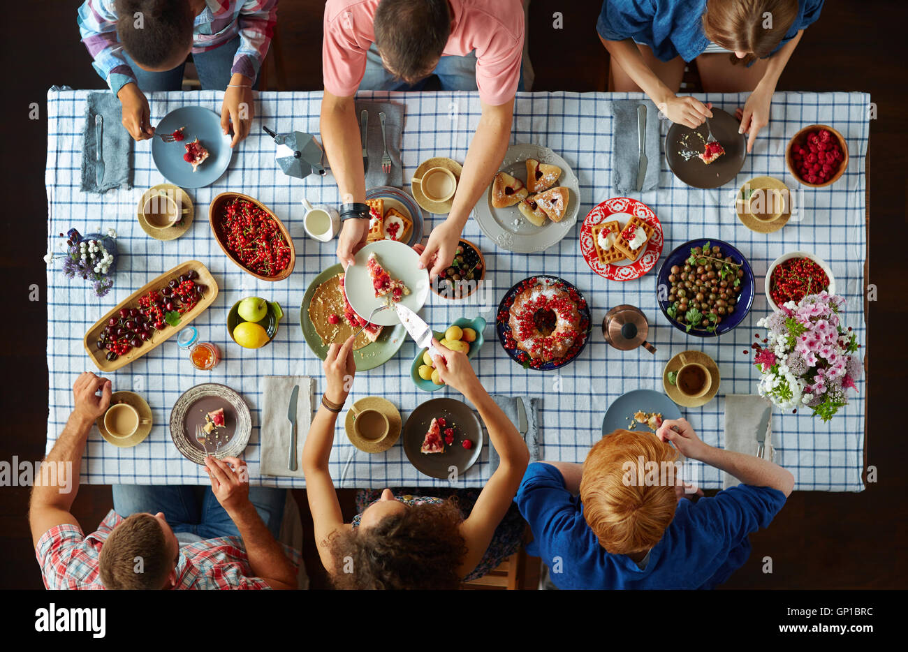 Group of young people having tasty dinner Stock Photo - Alamy