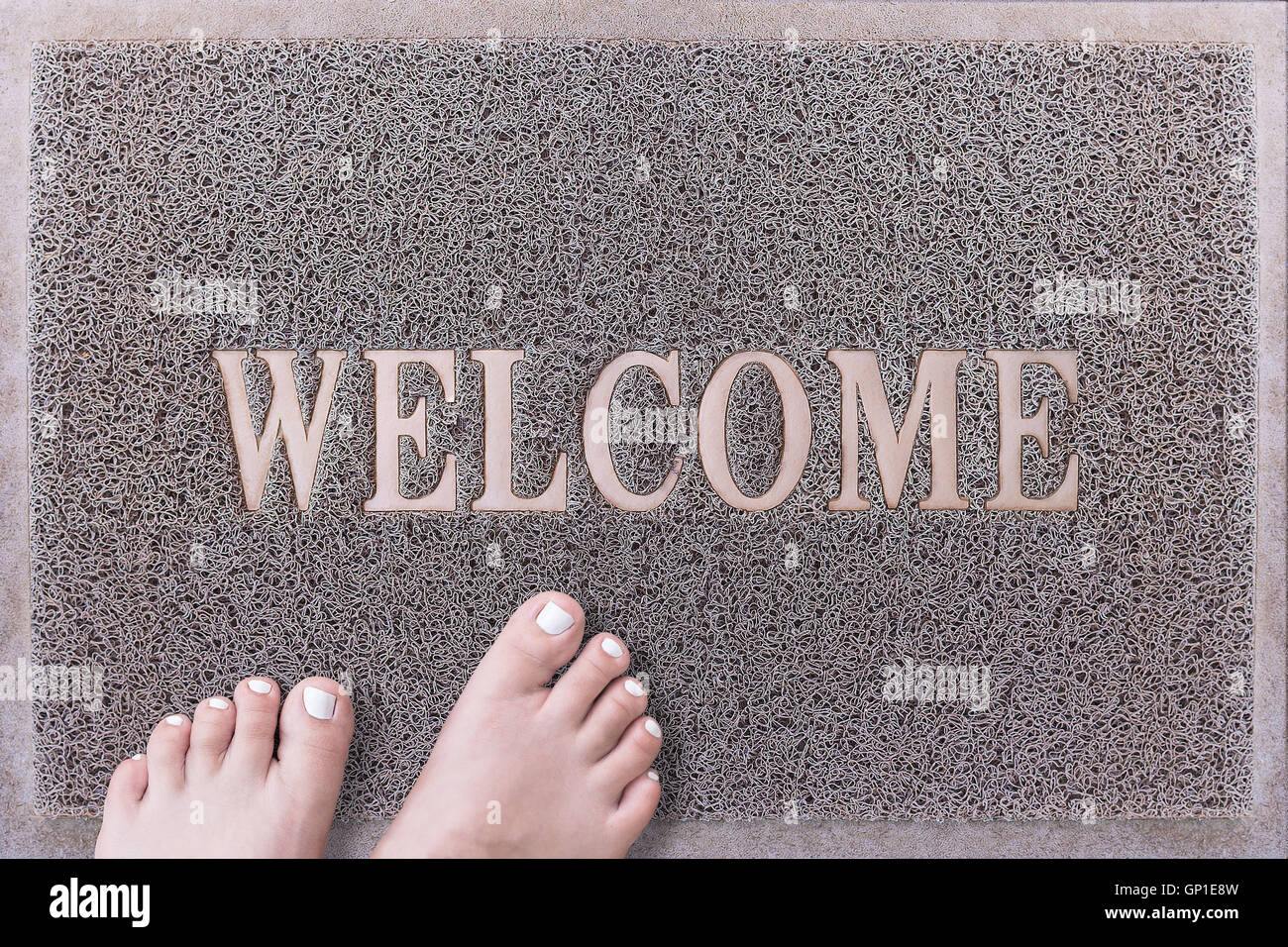 Welcome Door Mat With Female Feet. Friendly Grey Door Mat Closeup with ...