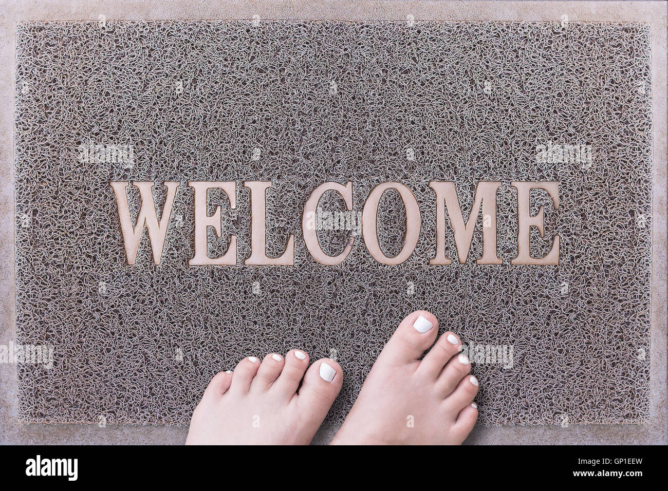 Welcome Door Mat With Female Feet. Friendly Grey Door Mat Closeup with ...