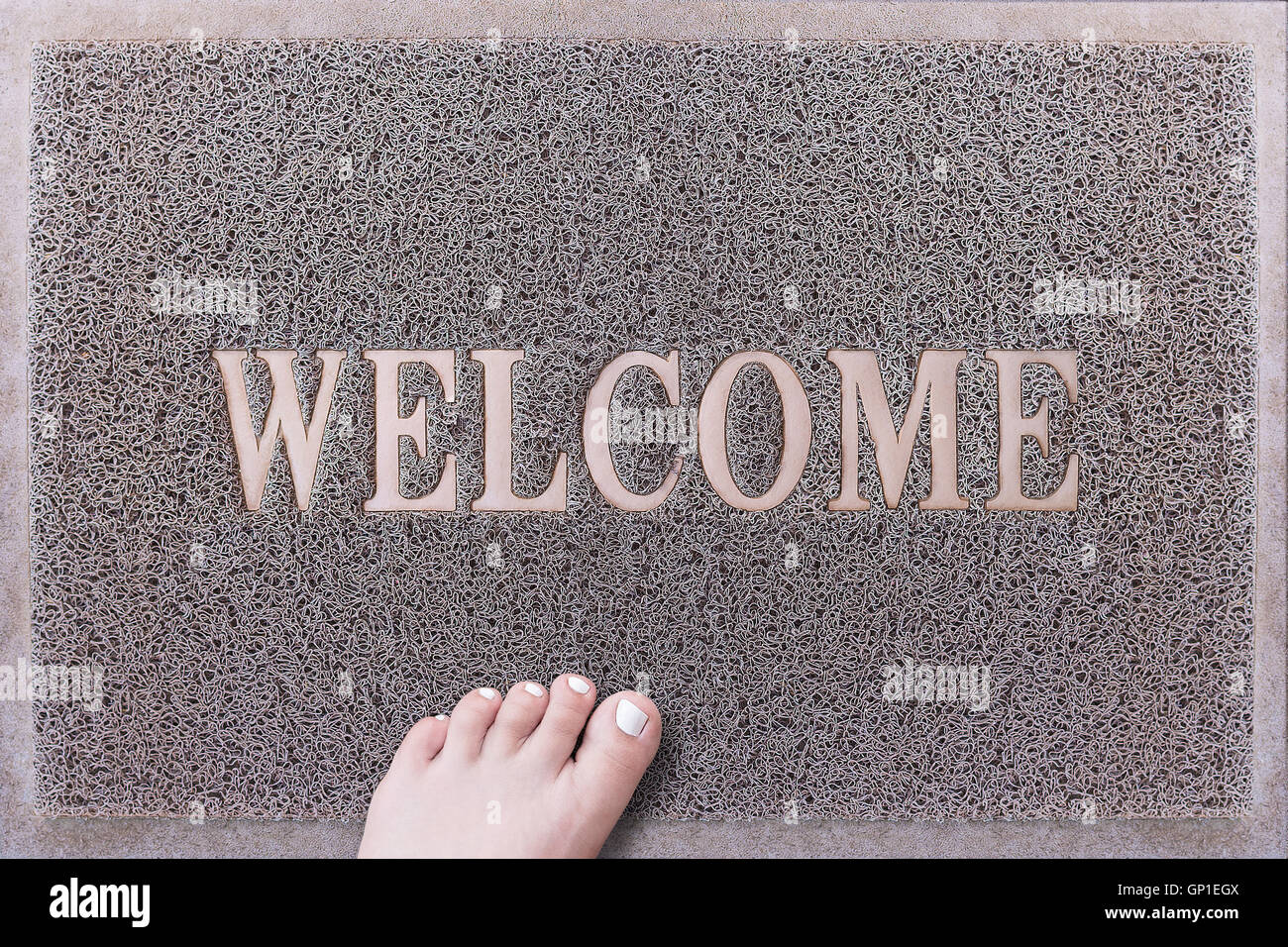 Welcome Door Mat With Female Foot. Friendly Grey Door Mat Closeup with ...
