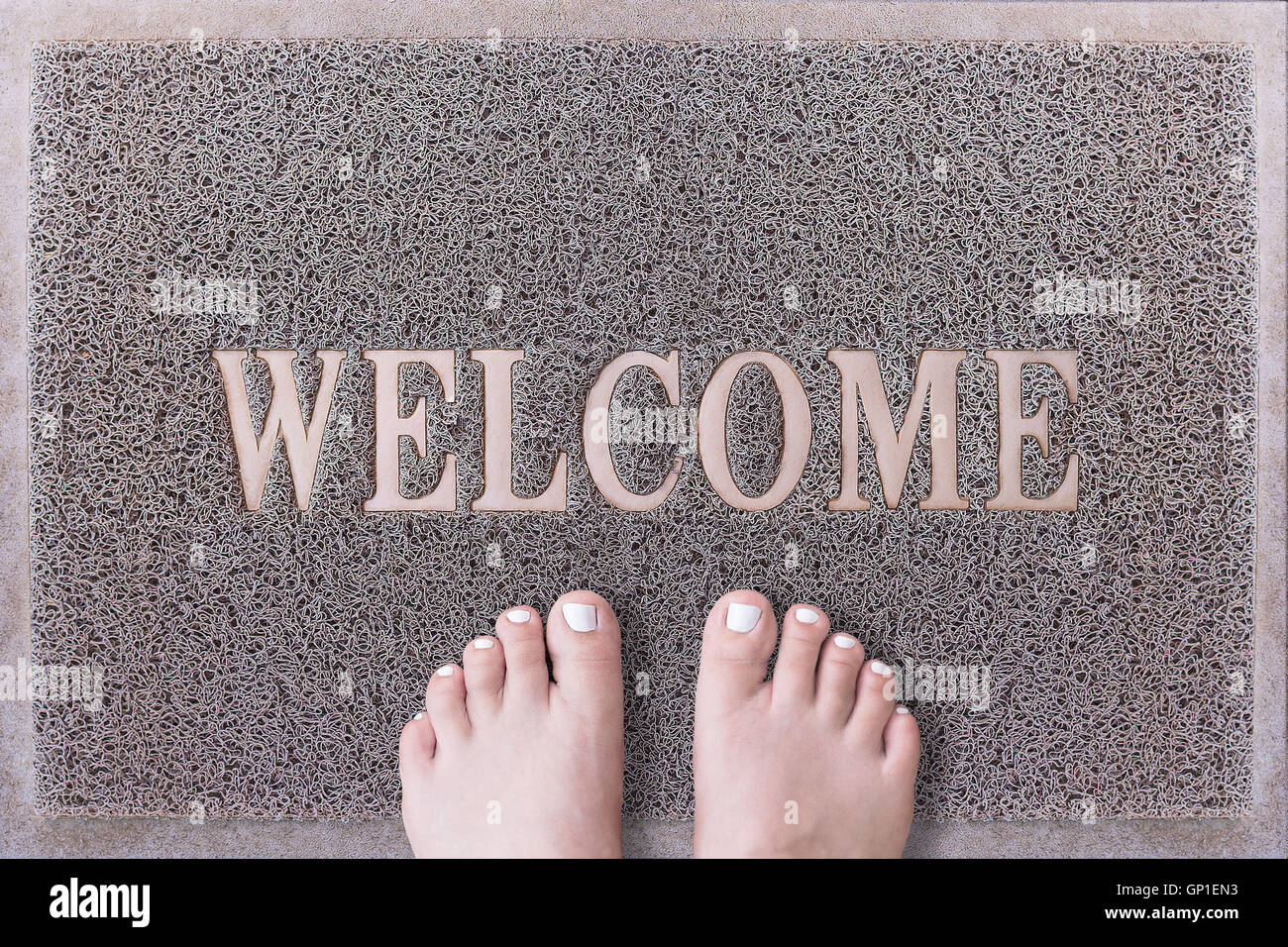 Welcome Door Mat With Female Feet. Friendly Grey Door Mat Closeup with ...