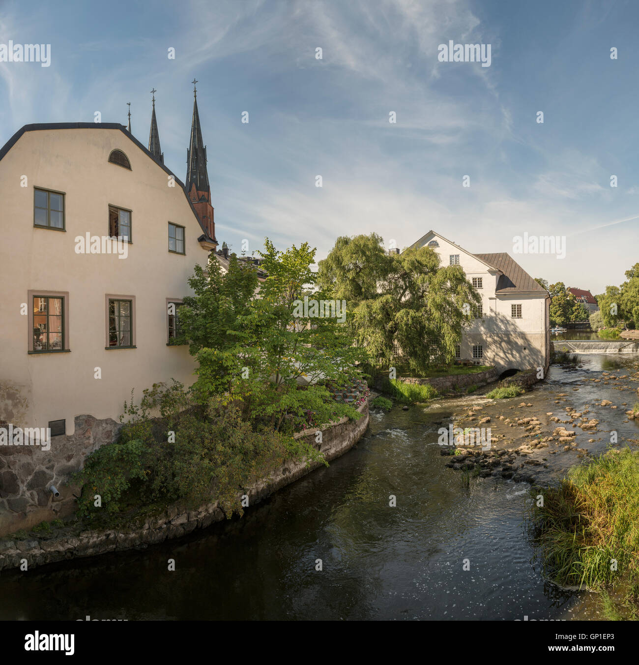 Old mill at Kvarnfallet in the Fyris river with the Uppsala Cathedral ...