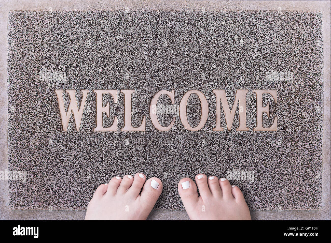 Welcome Door Mat With Female Feet. Friendly Grey Door Mat Closeup with ...