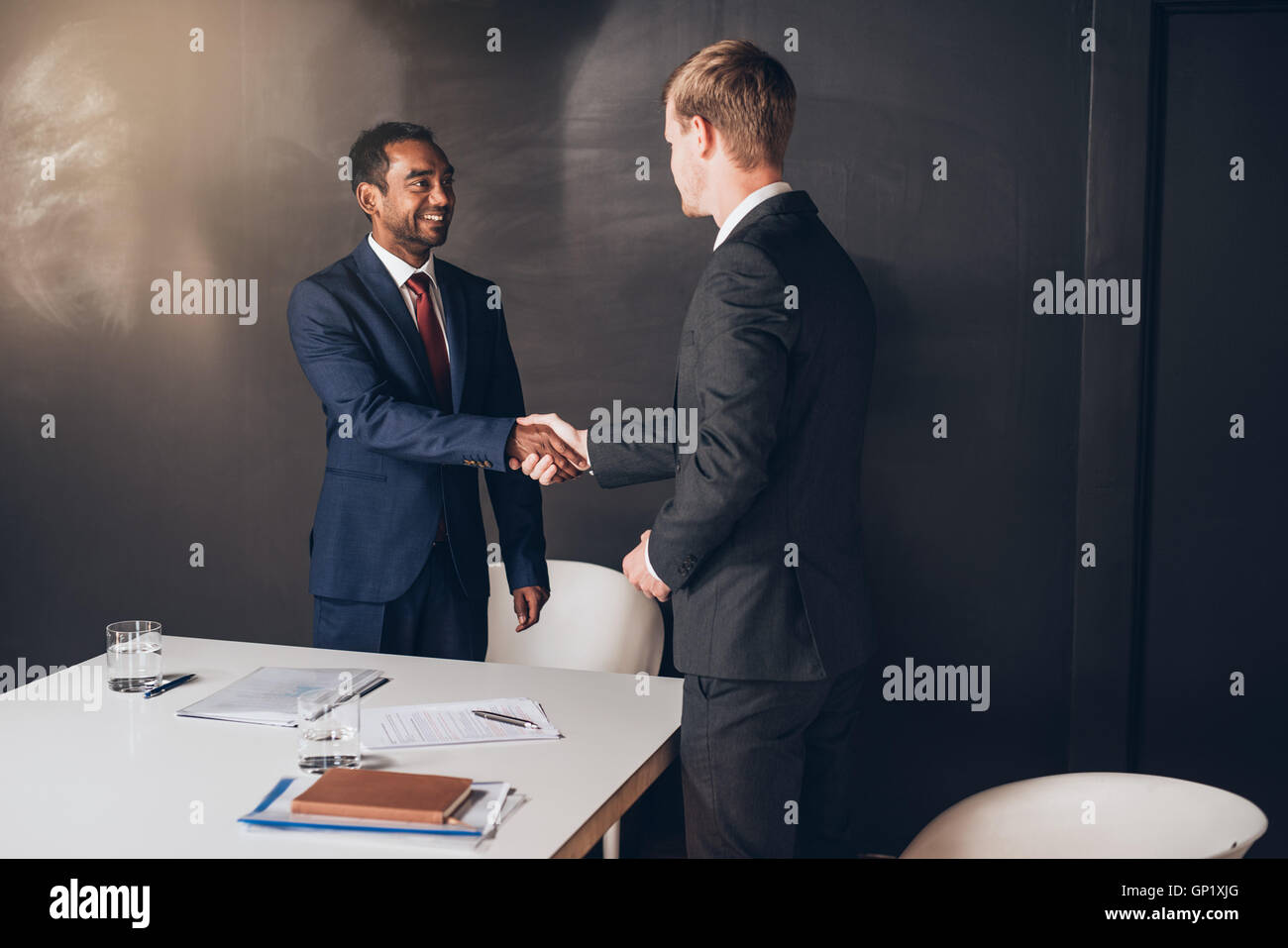 Shaking hands on a new merger Stock Photo - Alamy