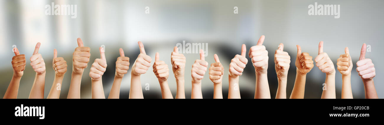 Many hands holding thumbs up in office Stock Photo - Alamy
