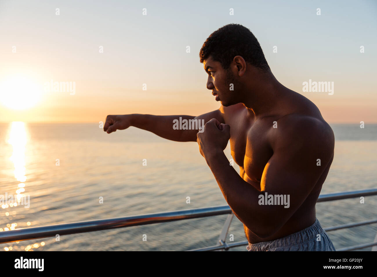 Silhouette of african american young man athlete practicing shadow ...