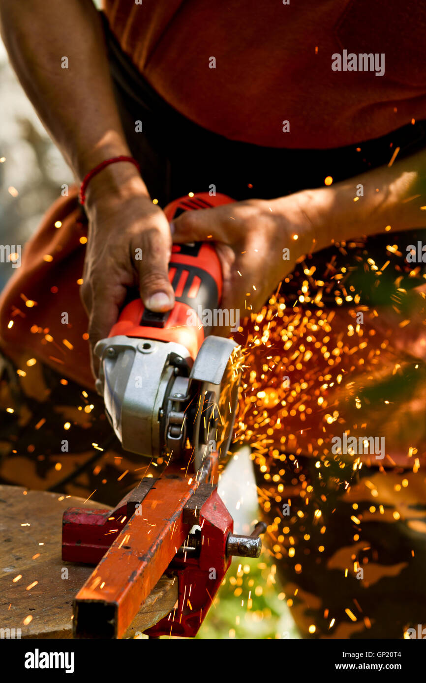 A latin american man grinding a peace of metal with his tools Stock ...