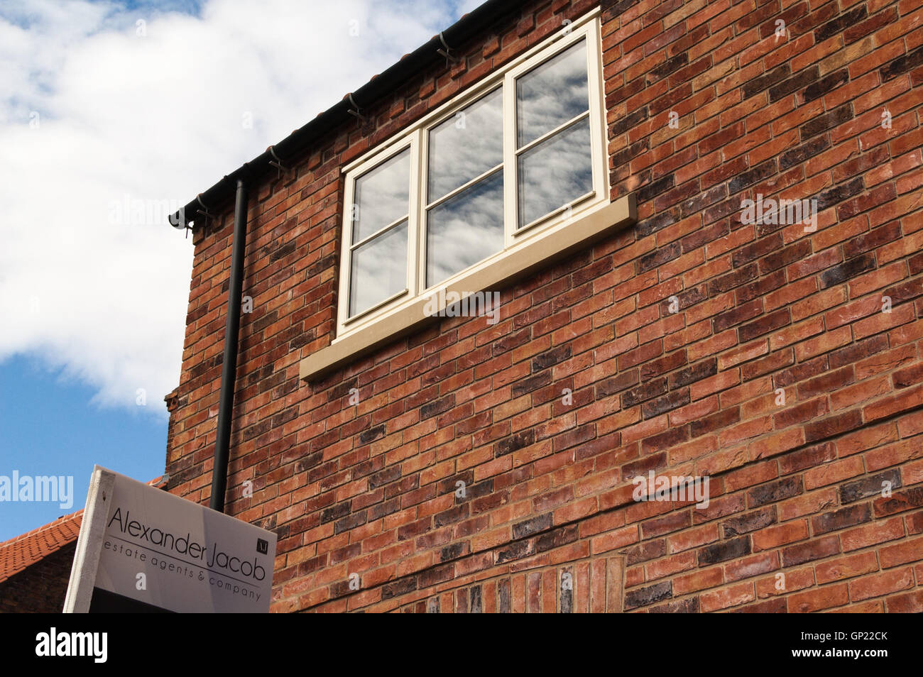 New build house using reclaimed brick House for sale Stock Photo - Alamy