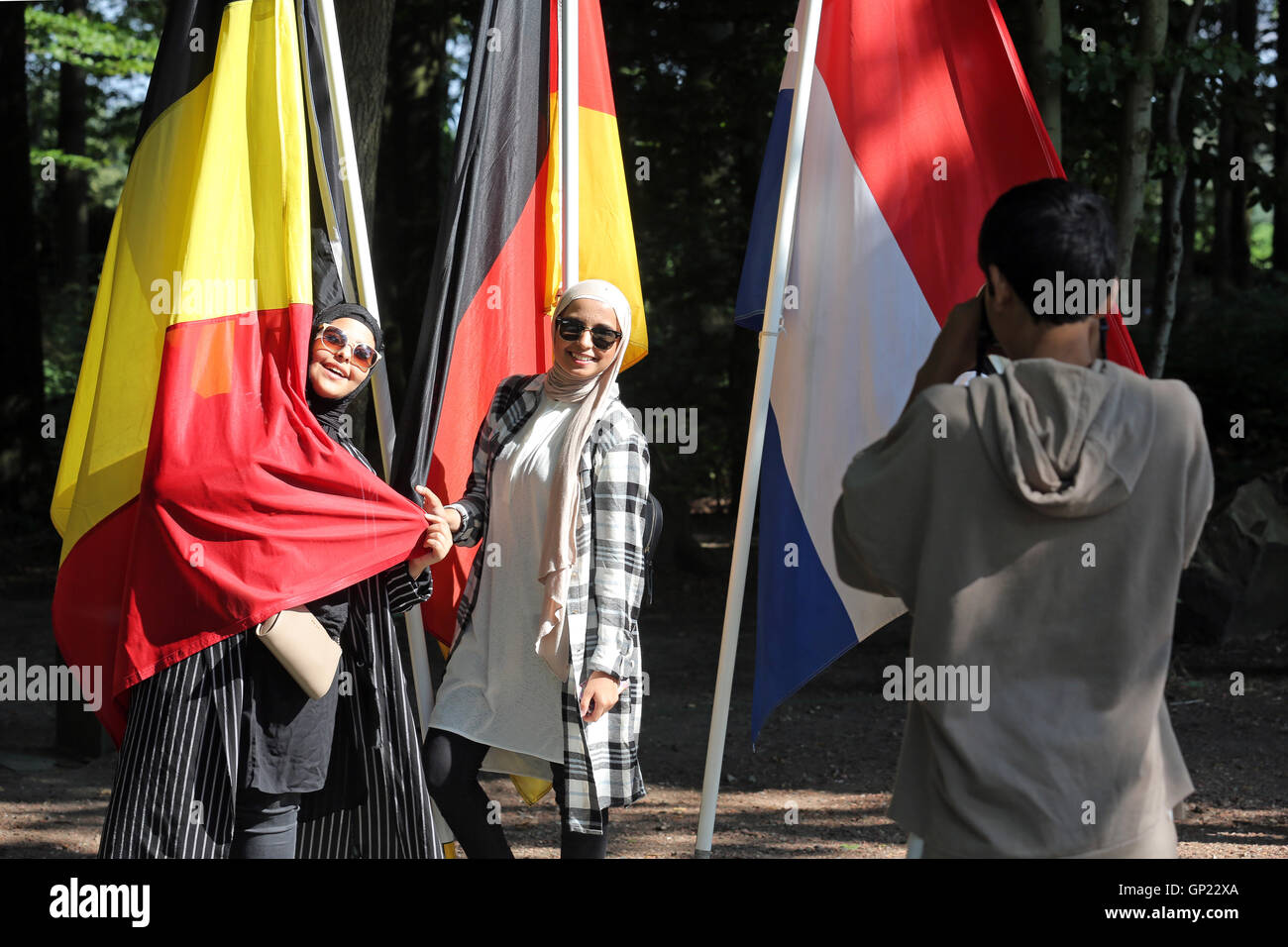 Young female Muslims are been photographed with the flags of Belgium ...