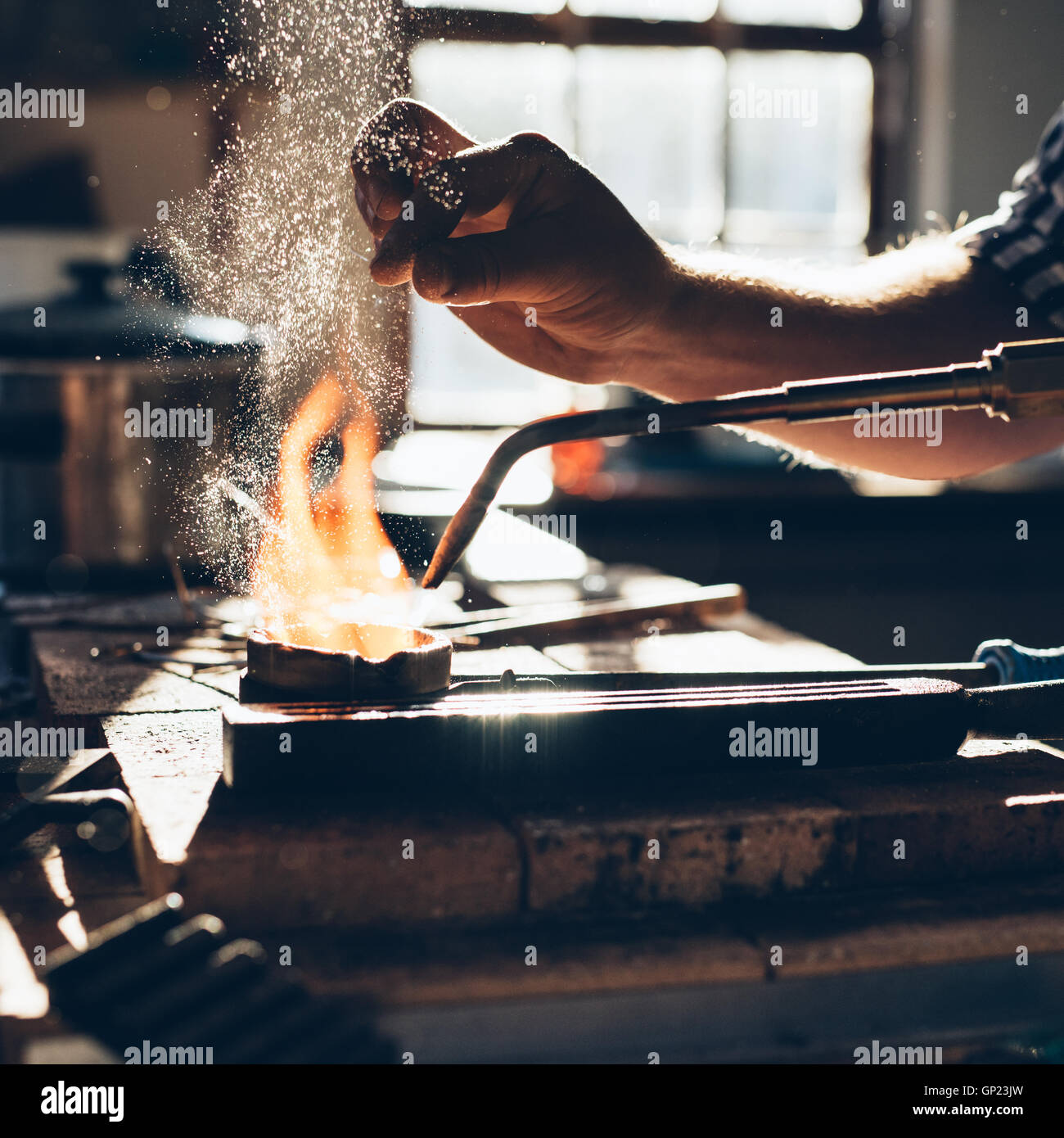 Working the metal in a crucible Stock Photo - Alamy