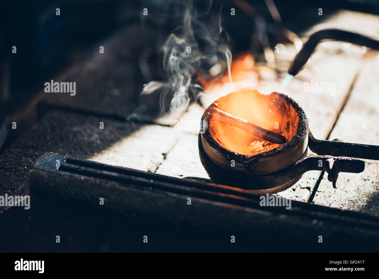 Melting down an ingot in the crucible Stock Photo - Alamy