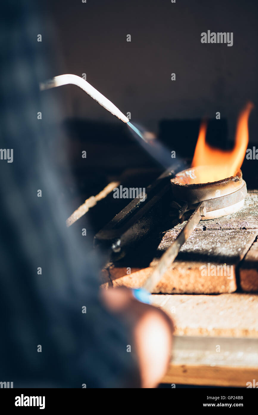 Masterfully melting metal in a crucible Stock Photo - Alamy