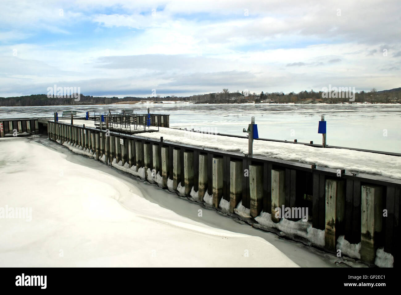 A dock and lake iced over in the winter Stock Photo - Alamy
