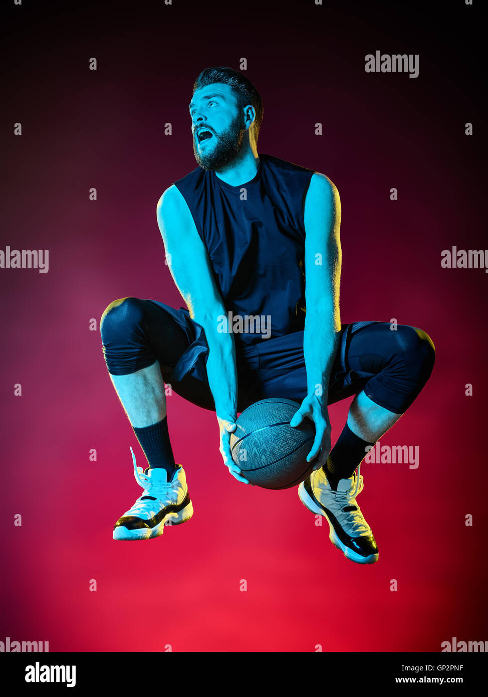 one basketball player man Isolated on black background Stock Photo - Alamy