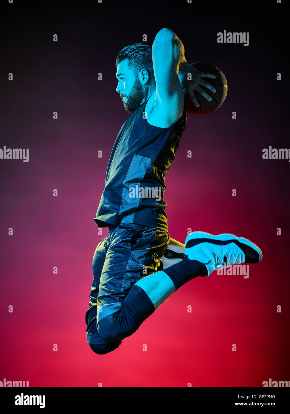 one basketball player man Isolated on black background Stock Photo - Alamy