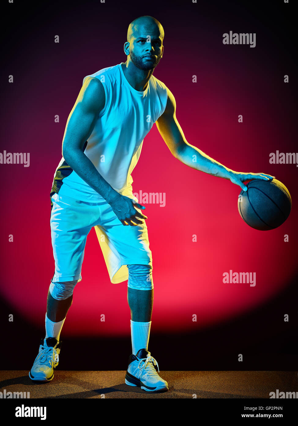 one basketball player man Isolated on black background Stock Photo - Alamy