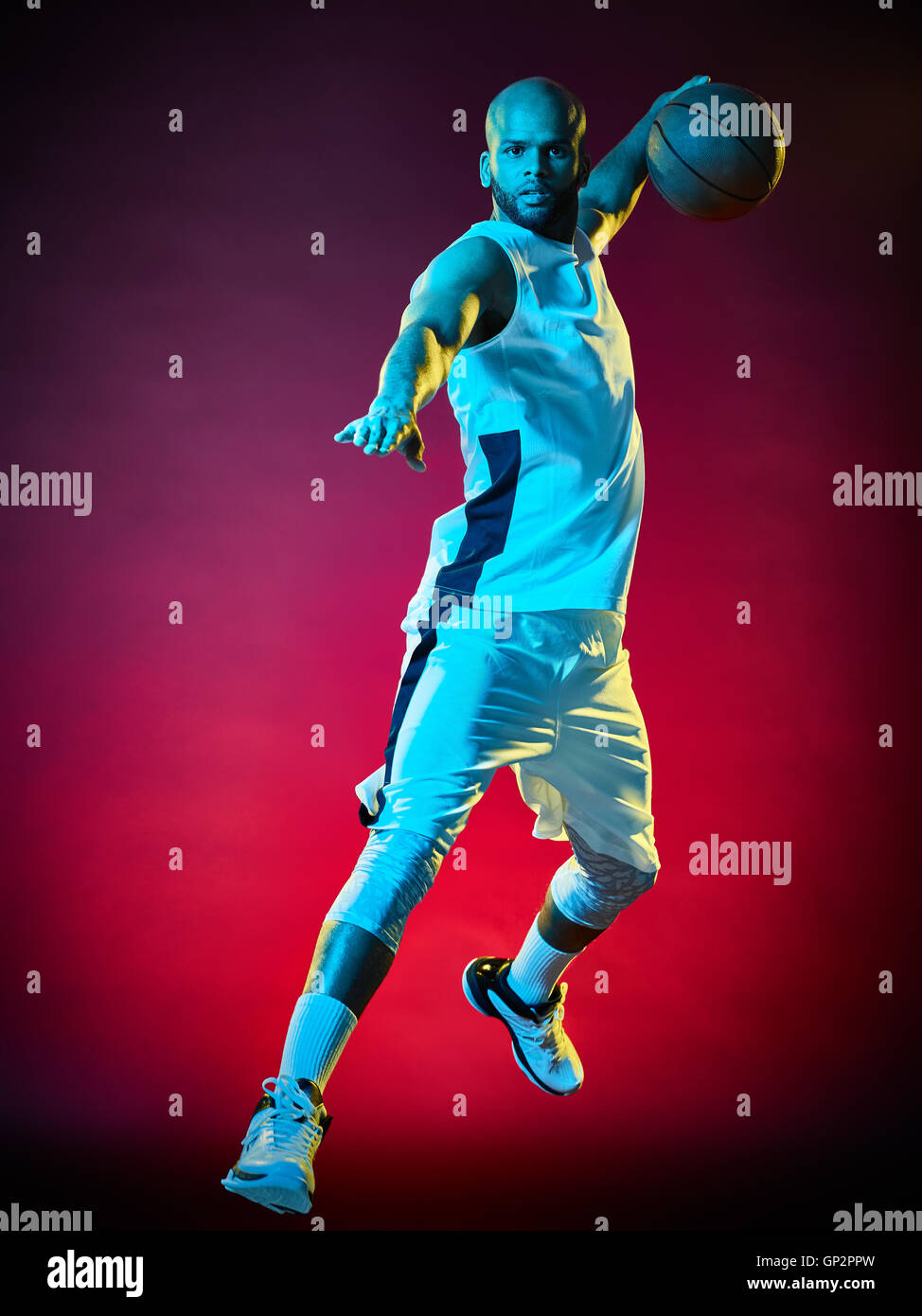 one basketball player man Isolated on black background Stock Photo - Alamy