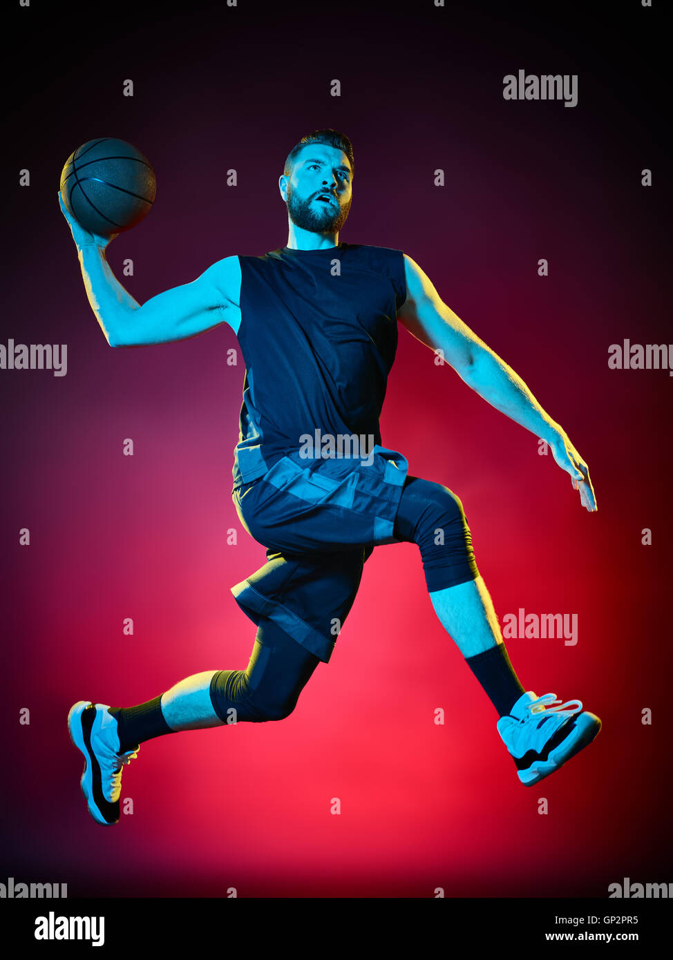 one basketball player man Isolated on black background Stock Photo - Alamy