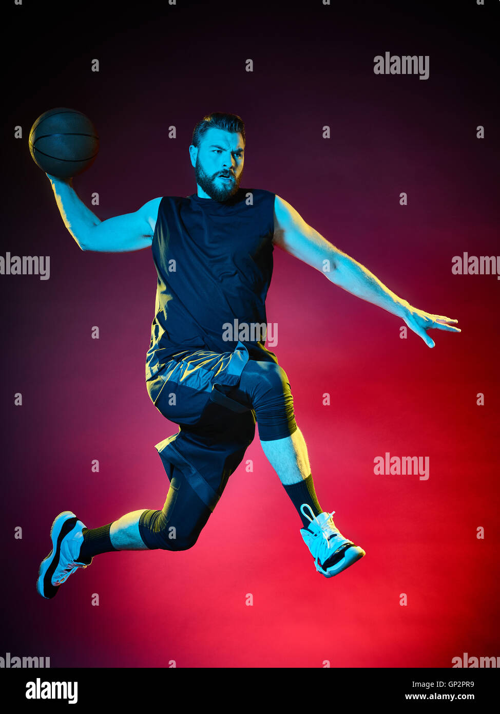 one basketball player man Isolated on black background Stock Photo - Alamy