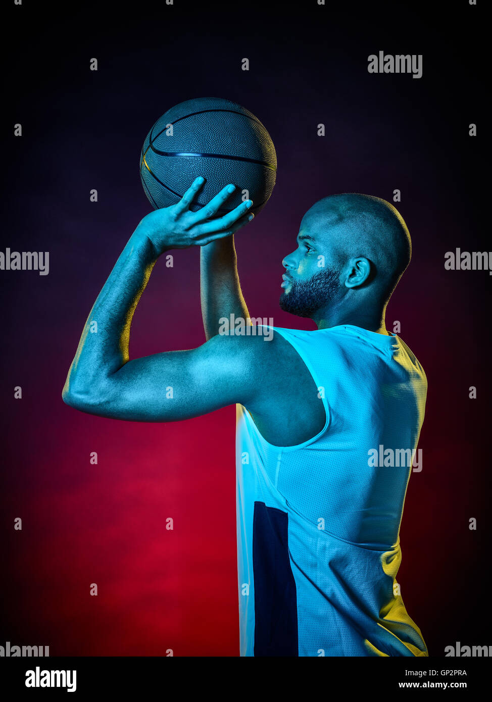 one basketball player man Isolated on black background Stock Photo - Alamy